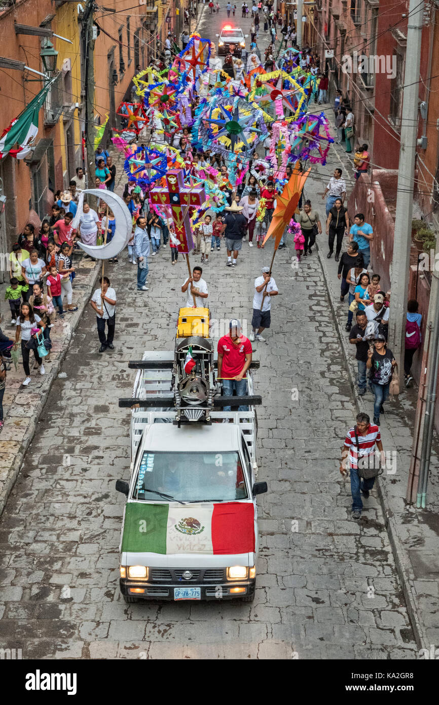 Railroad workers lead a fiesta procession through the city at the start ...