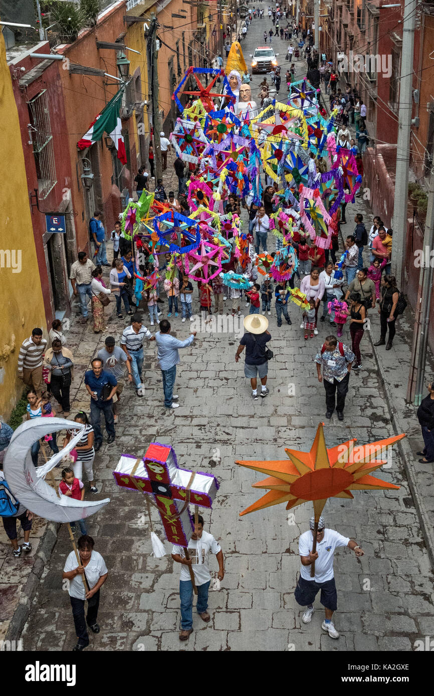 Railroad workers lead a fiesta procession through the city at the start ...