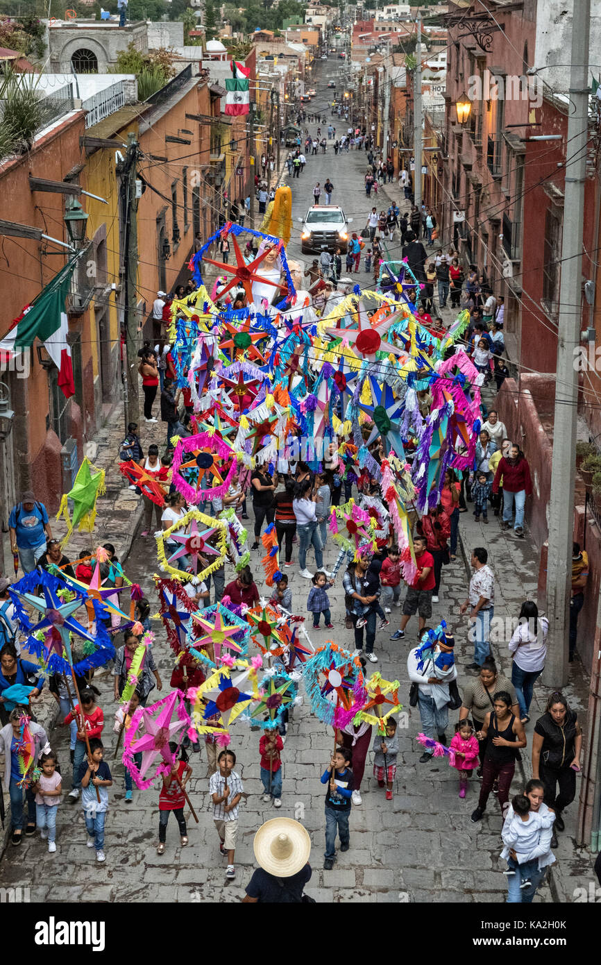Railroad workers lead a fiesta procession through the city at the start ...