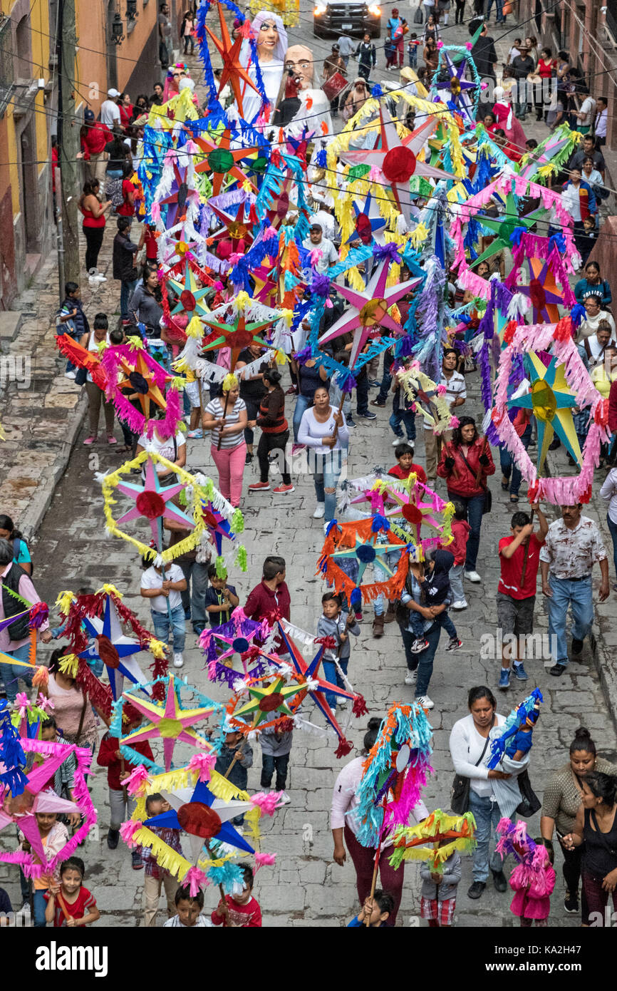 Railroad workers lead a fiesta procession through the city at the start ...