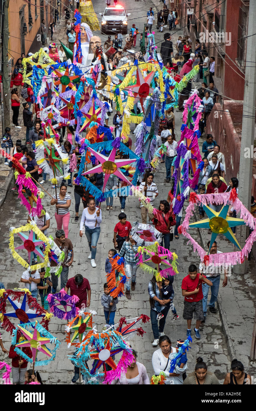 Railroad workers lead a fiesta procession through the city at the start ...