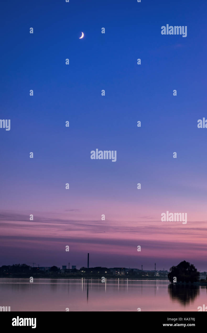 Moon watching over the lake Stock Photo - Alamy