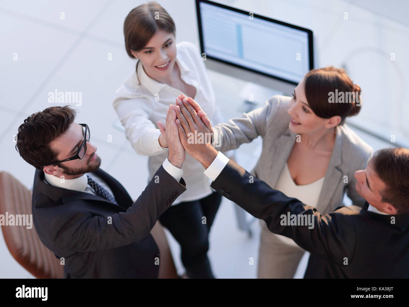 successful business team giving each other a high-five, standing in the ...