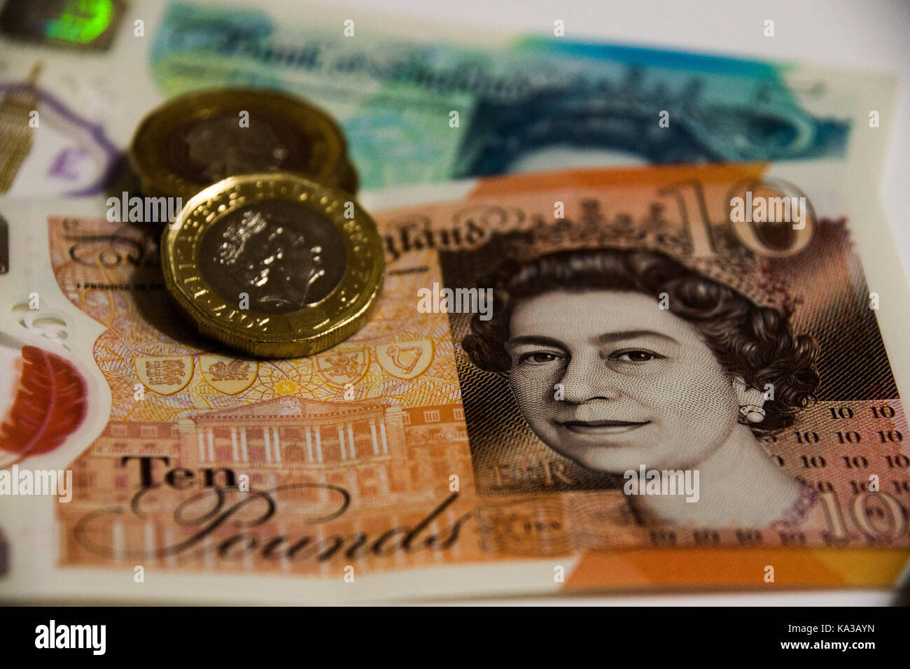 Polymer currency note and twelve sided pound sterling coin in full ...