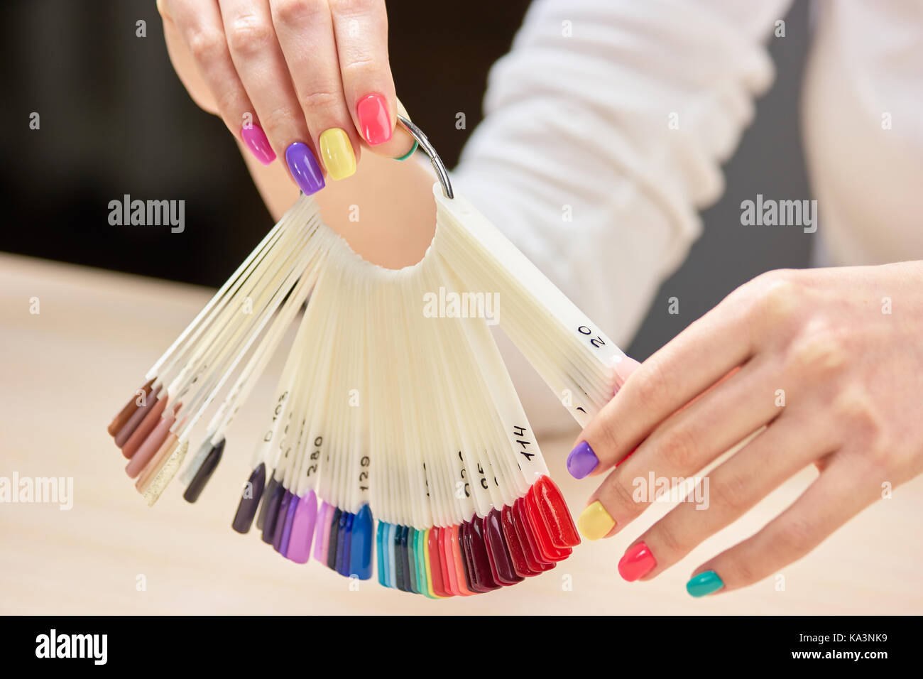 Nails colors samples in female hands. Girl with beautiful summer ...