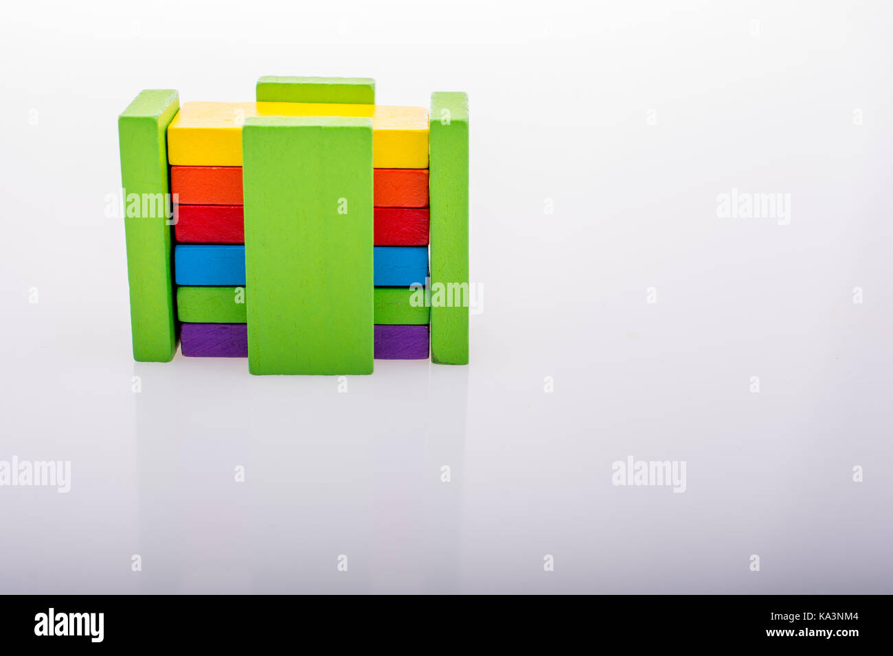 Colorful Domino Blocks in a line on a white background Stock Photo - Alamy
