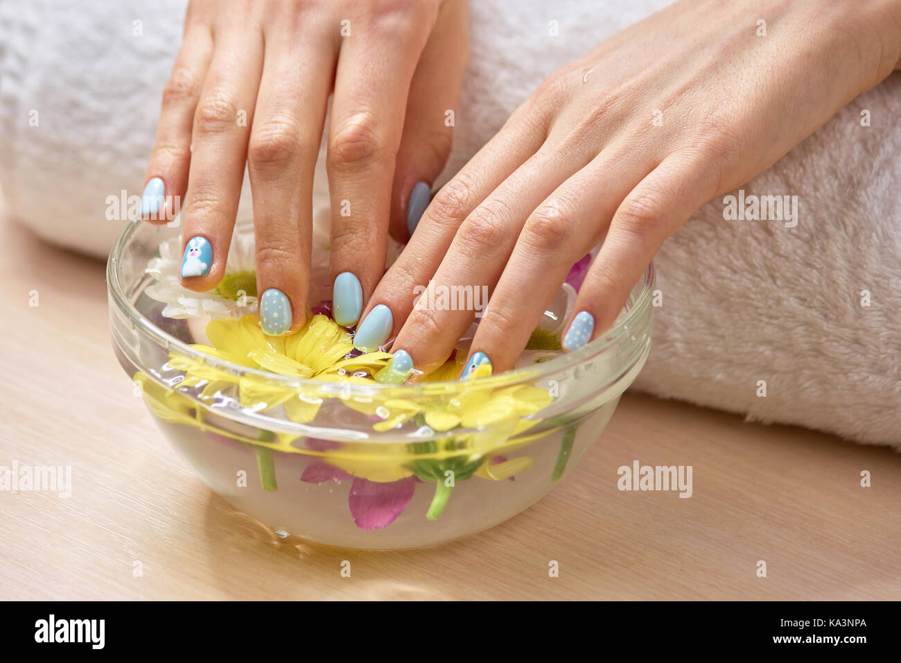 Female fingernails soaking in hand bath. Beautiful young woman hands ...