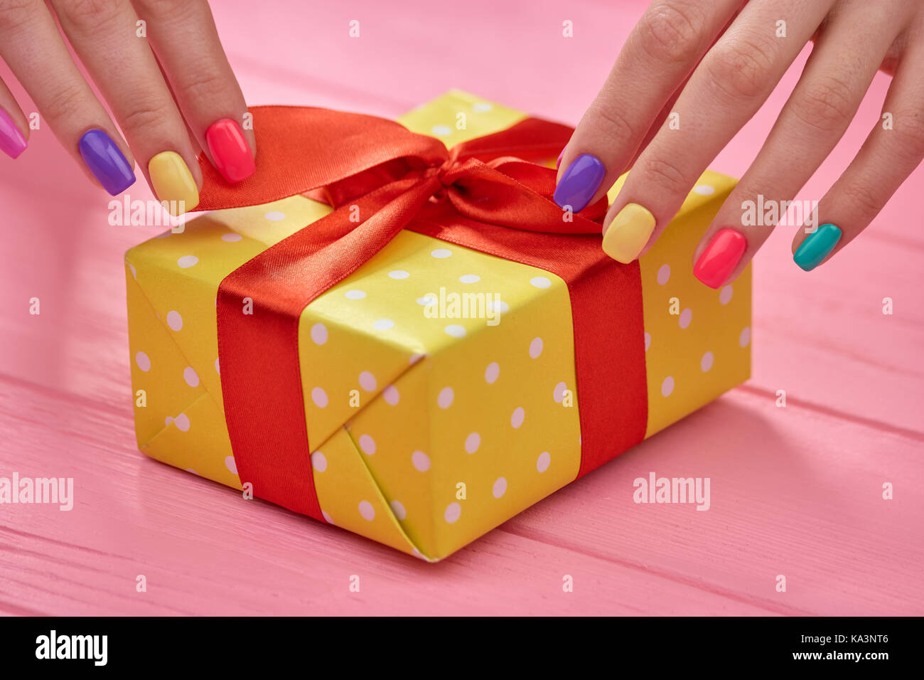 Female hands unpacking gift box. Female manicured hands going untied ...