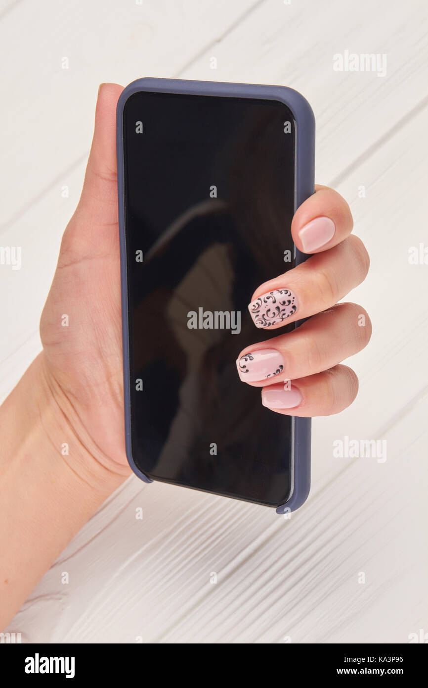 Beautiful female hand holding smartphone. Woman hands with gentle ...
