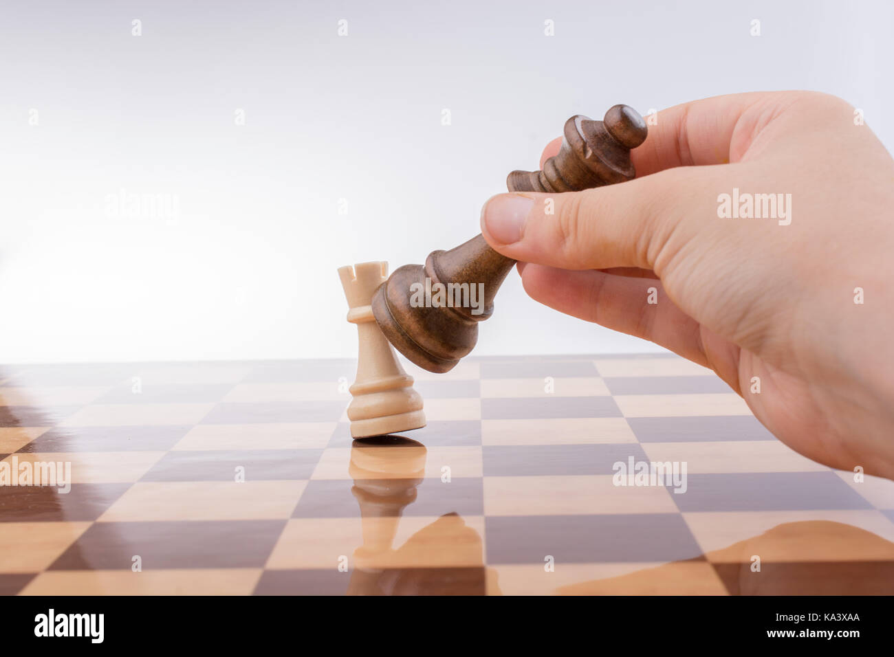 Person playing chess game making a move on board Stock Photo - Alamy
