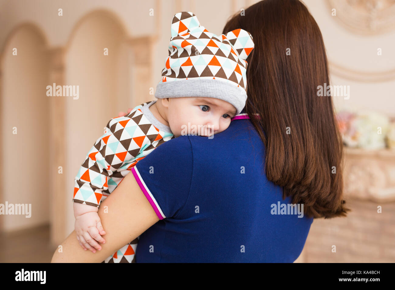 Adorable Caucasian baby with his mother. Portrait of a three months old ...