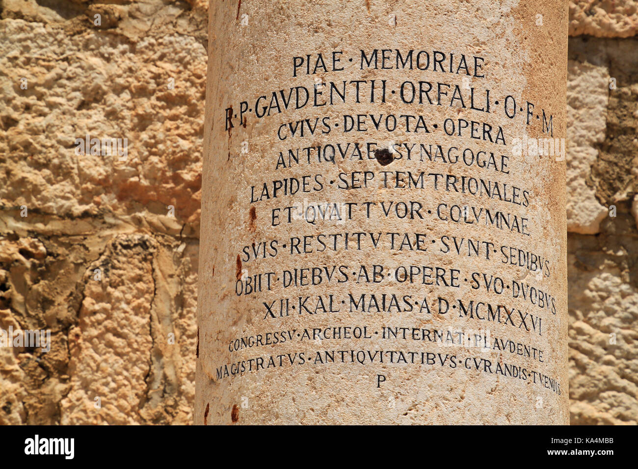 Latin inscribed basalt column at the ancient ruins of Capernaum, Israel ...