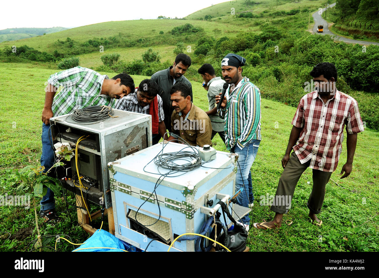 Director, staff and actors on a chair is watching a performance at ...