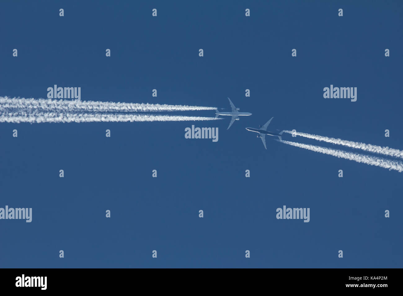Two passengers jets are flying to each other in blue sky Stock Photo ...