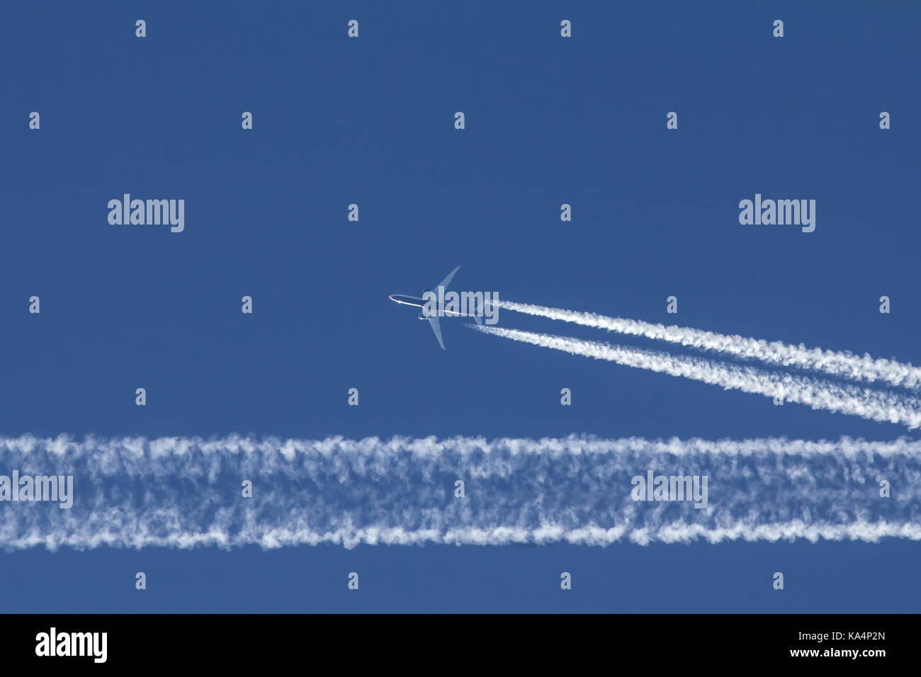 Passengers jet is flying in perfect blue sky Stock Photo - Alamy