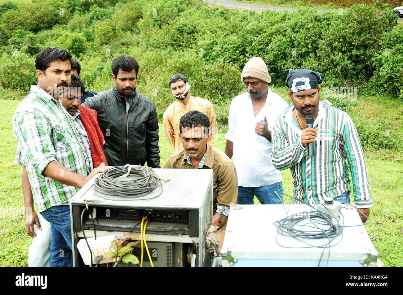 Director, staff and actors on a chair is watching a performance at ...
