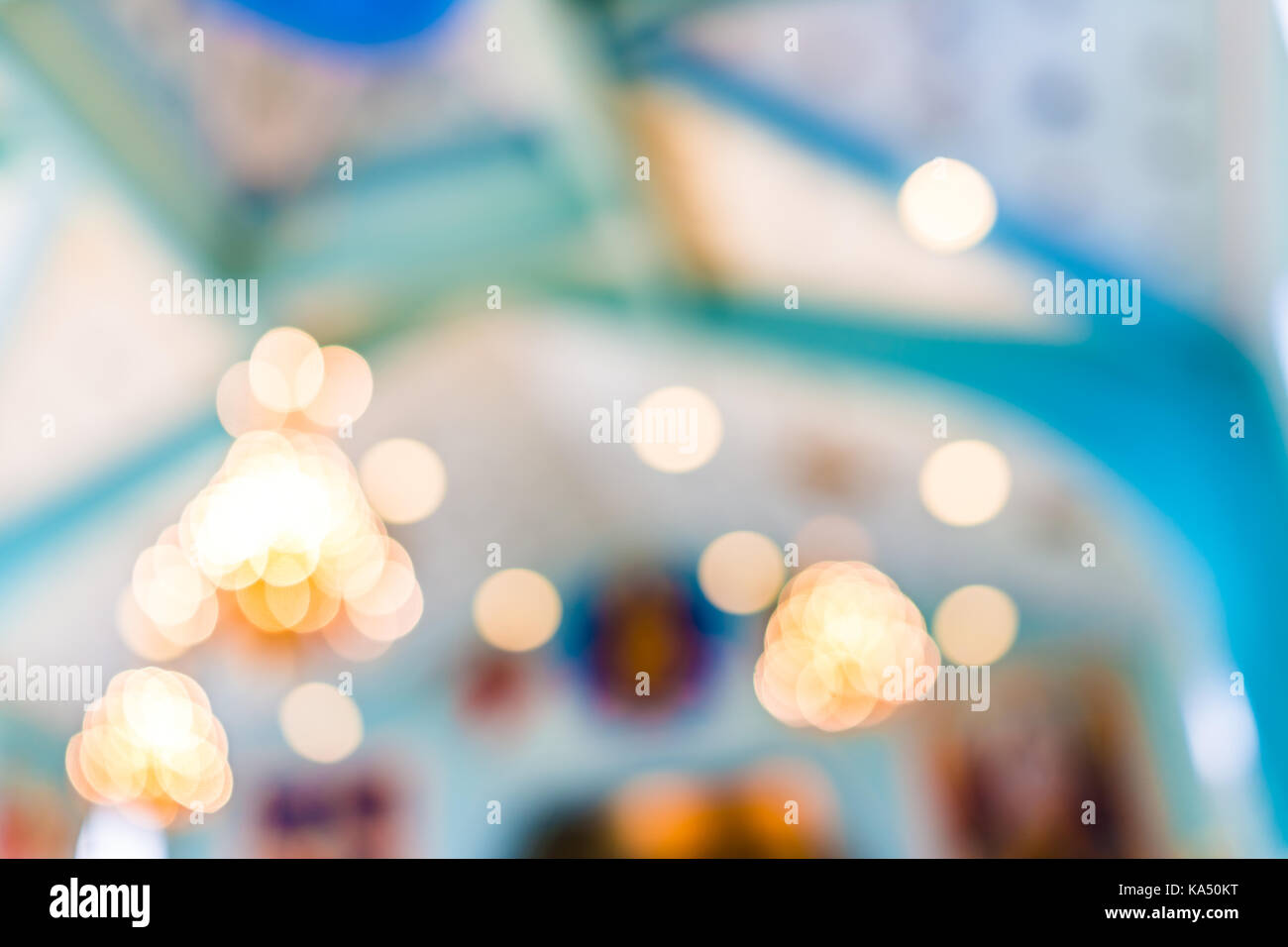 Bokeh abstract background of bright lights inside blue orthodox church ...