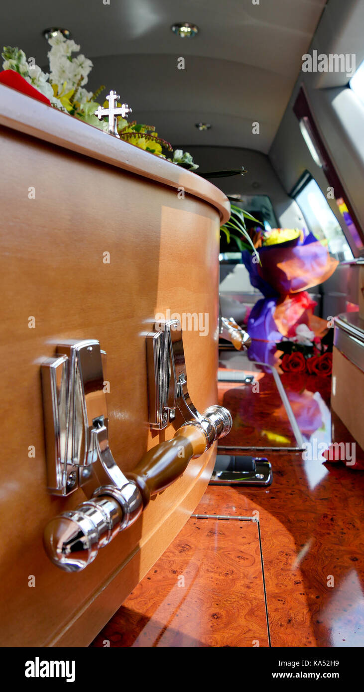closeup shot of a colorful casket in a hearse or chapel before funeral ...