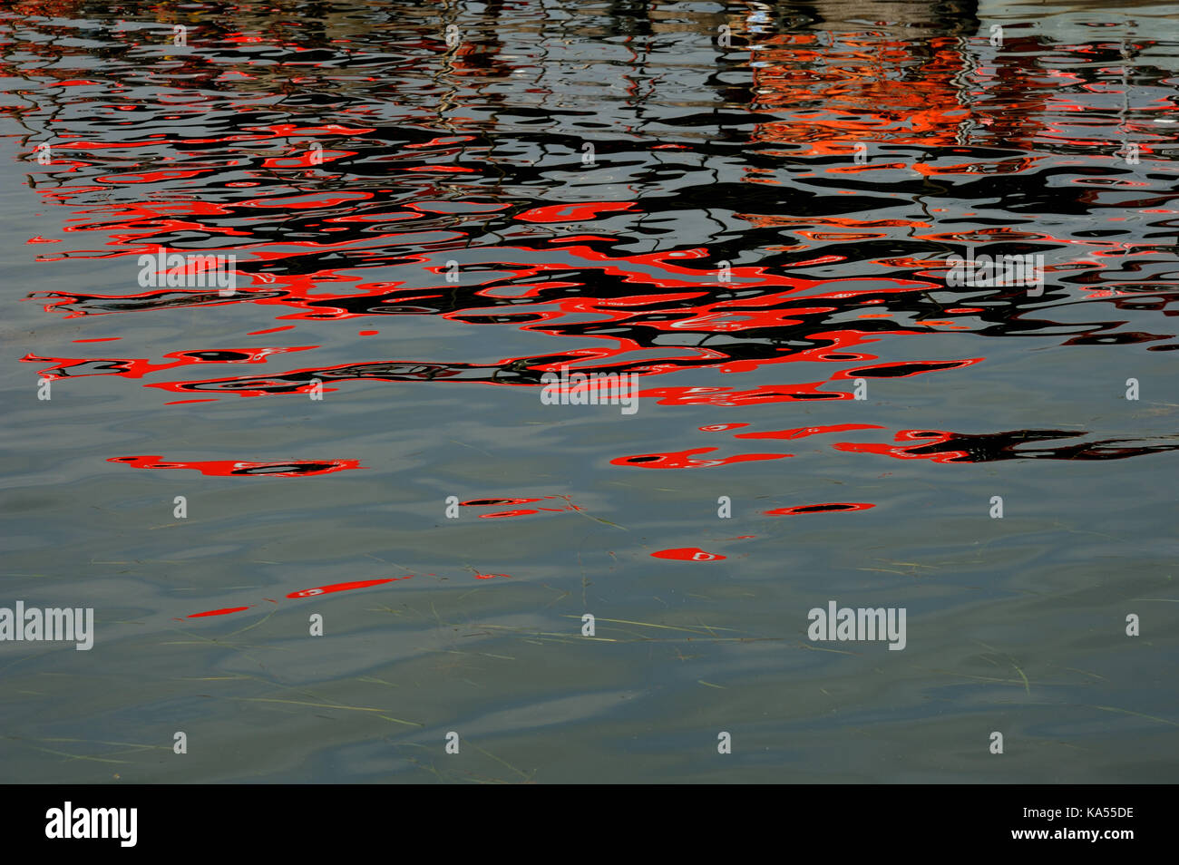Abstract red reflection of boat on water , India, Asia Stock Photo - Alamy