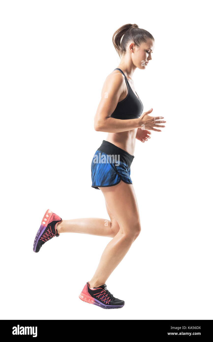 Side view of sporty athletic female jogger jogging and looking down ...
