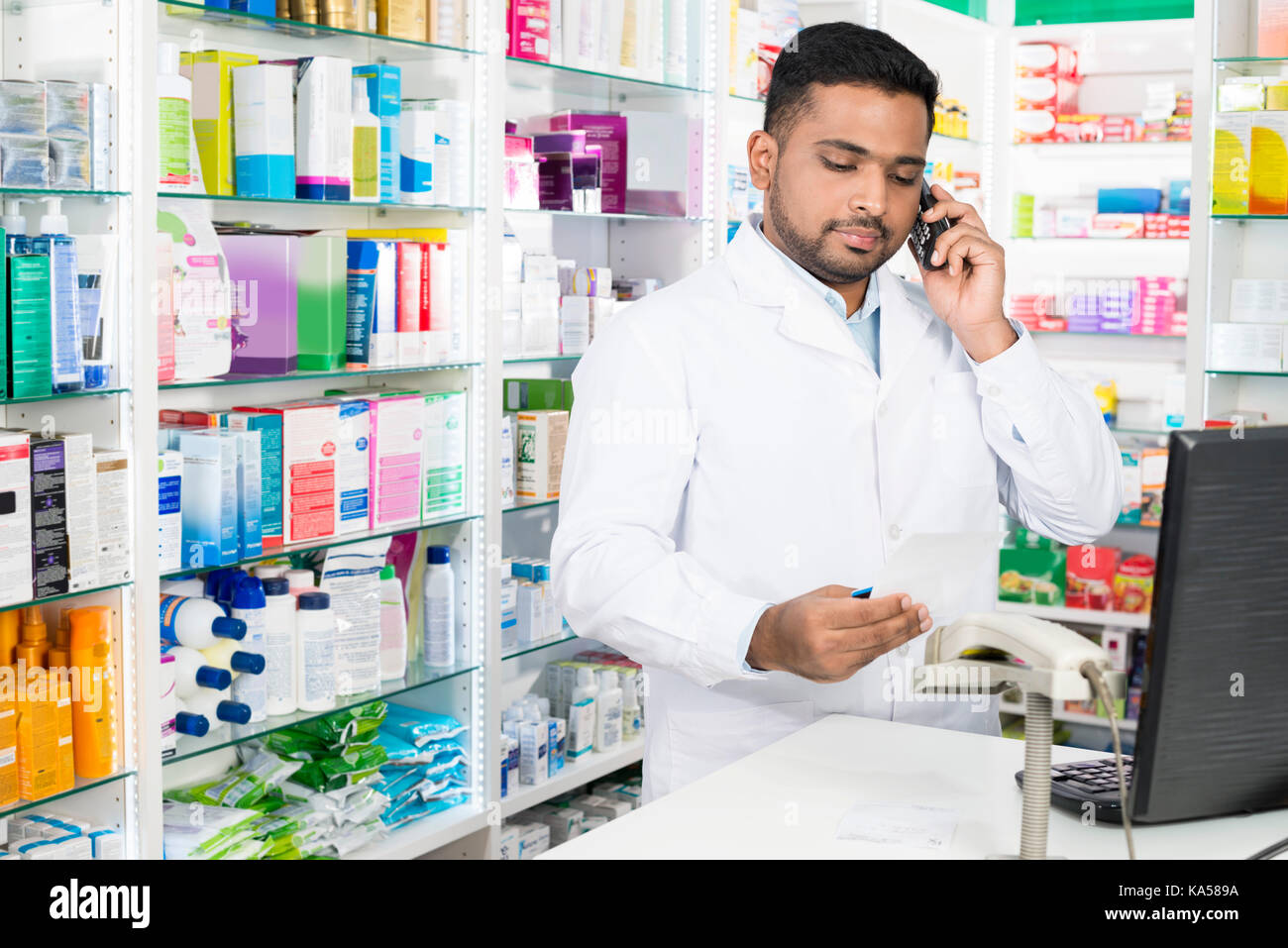 Confident Pharmacist Using Phone While Holding Prescription Pape Stock ...