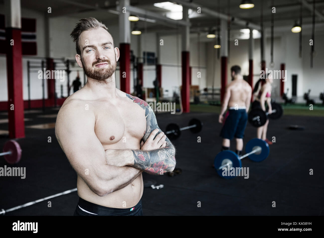 Proud Man Standing Arms Crossed In Gym Stock Photo - Alamy