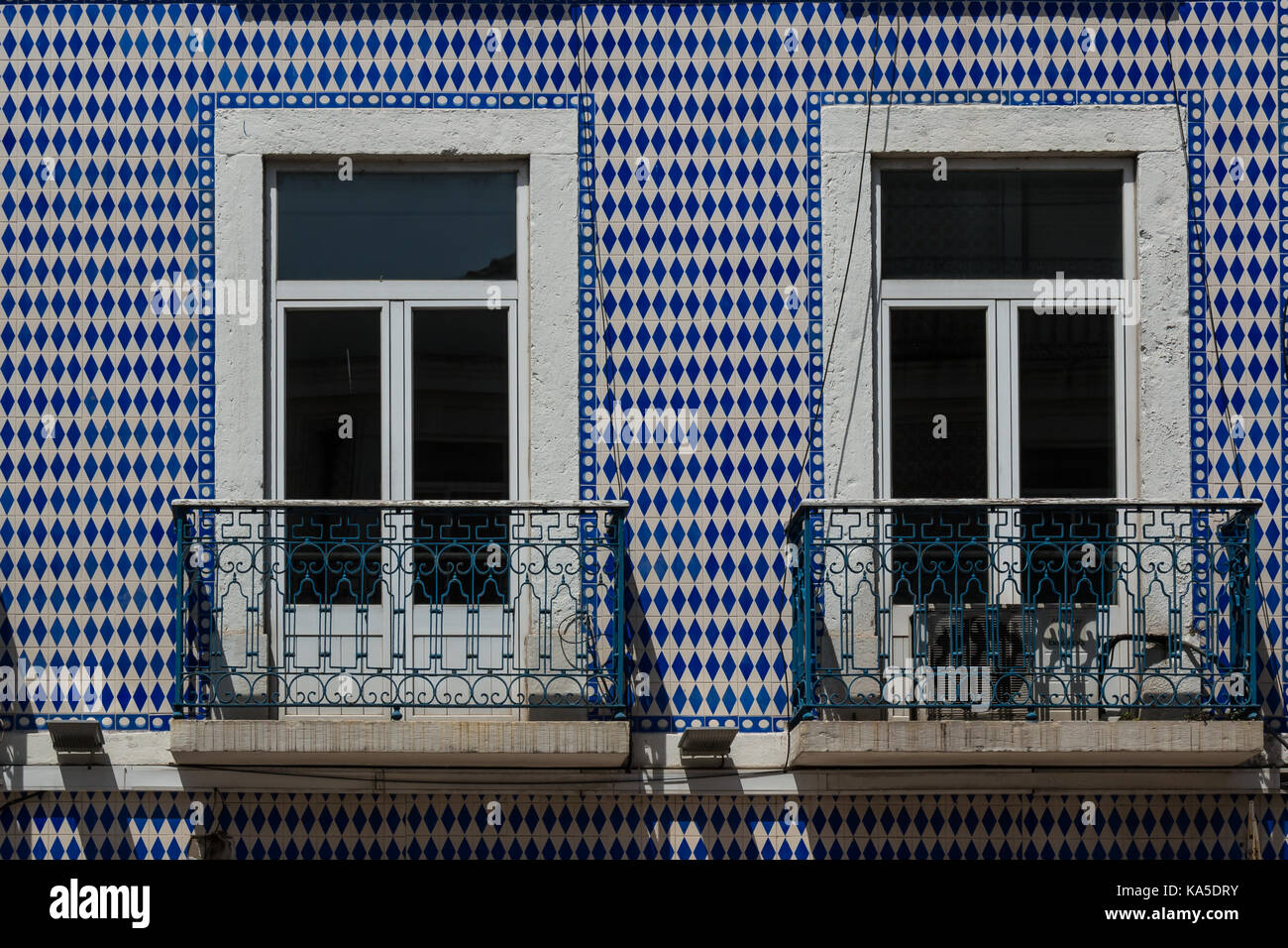 Two closed windows and balconies. Facade of the house with simple ...