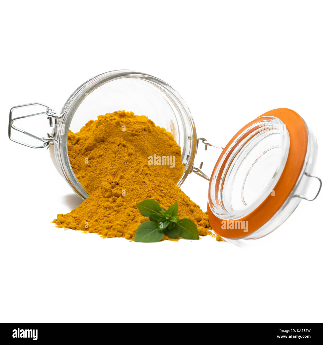 raw and powder turmeric and powder in a glass storage jar, used for ...