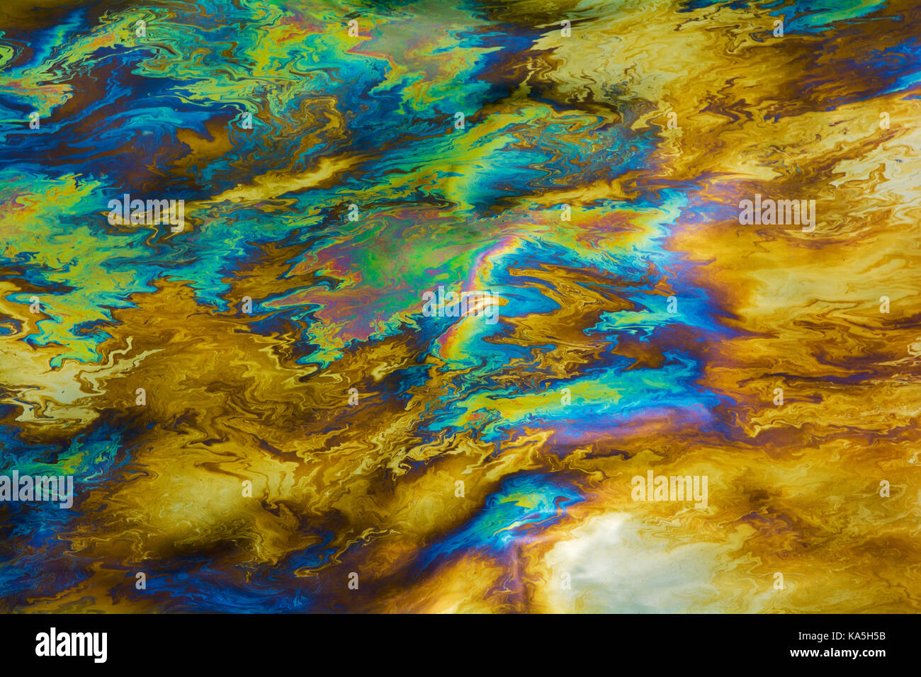 Colourful oil patches on water Stock Photo - Alamy