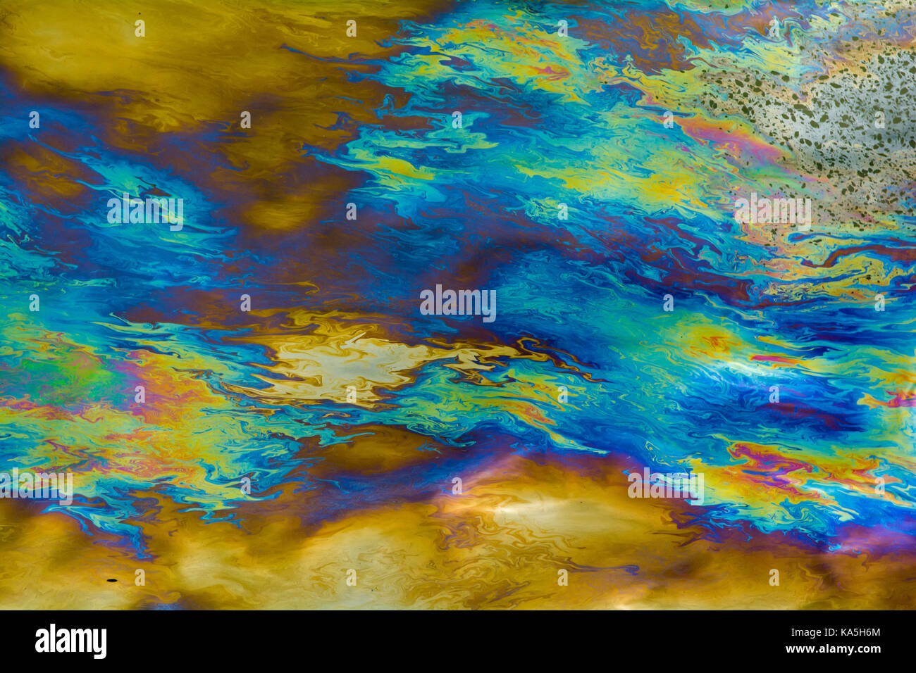 Colourful oil patches on water Stock Photo - Alamy