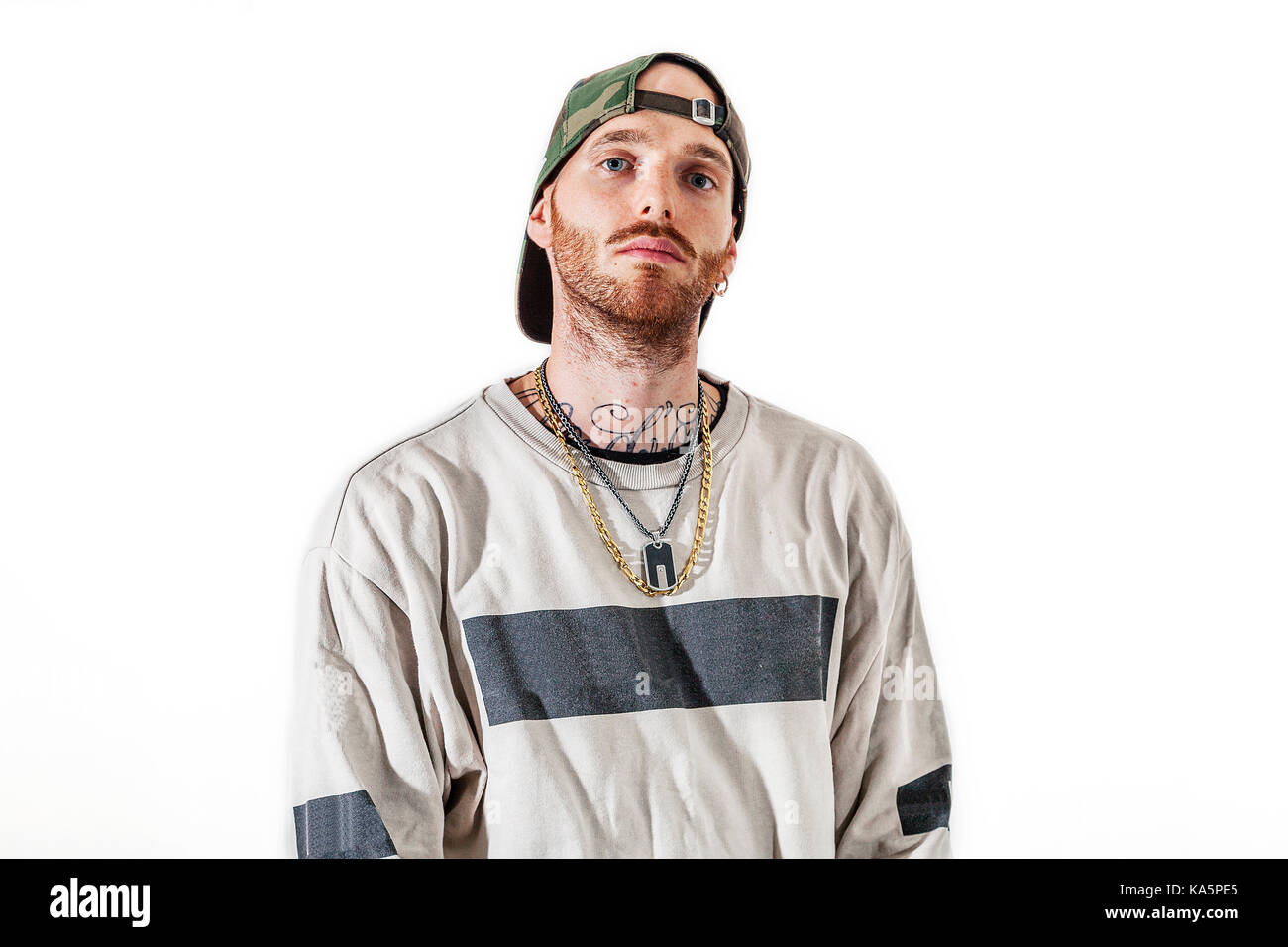 tattooed rap singer posing in studio on a white background Stock Photo ...