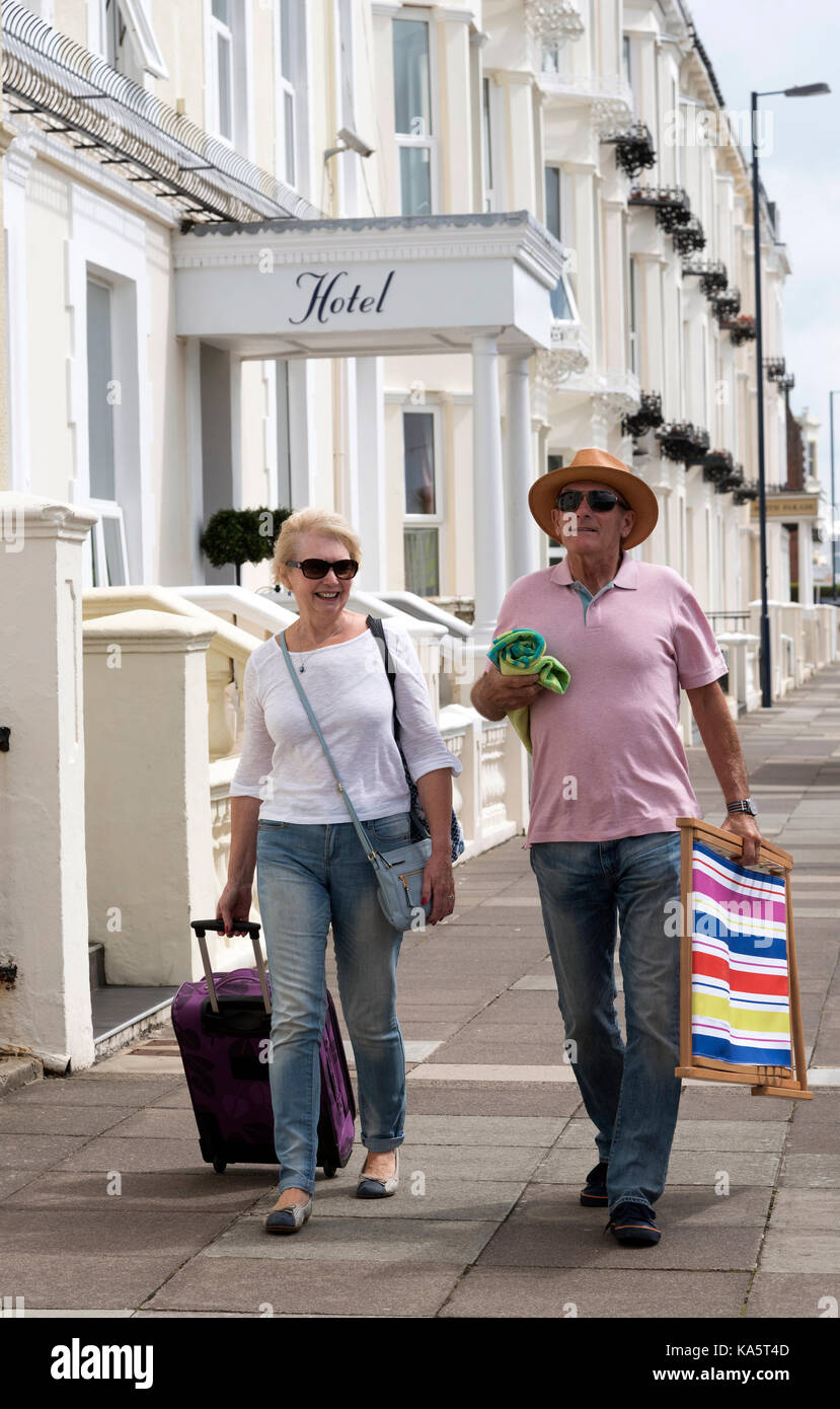 Holidaymakers in a seaside town walking to their hotel Stock Photo - Alamy