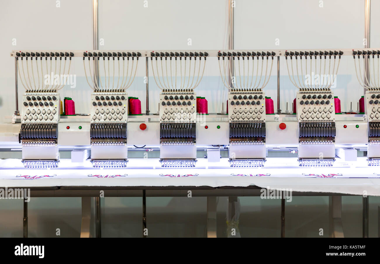 Professional sewing machine in work on textile fabric, nobody. Factory ...