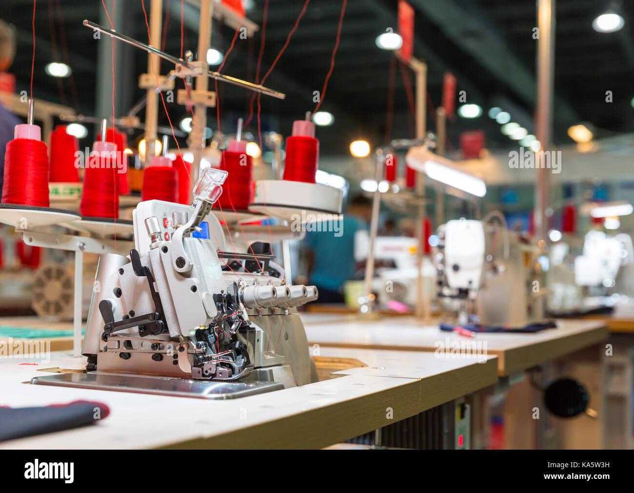 Overlock machine on sewing factory, nobody. Clothing sew. Textile ...