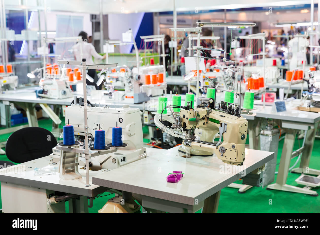 Dressmaker workplace, sewing machines on factory. Overlock machine ...