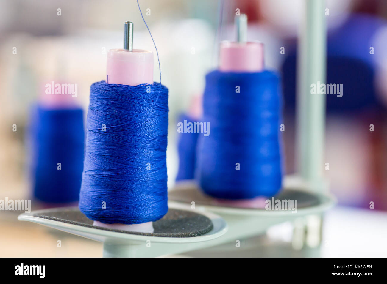Spools of threads closeup, sewing fabric. Textile manufacturing ...