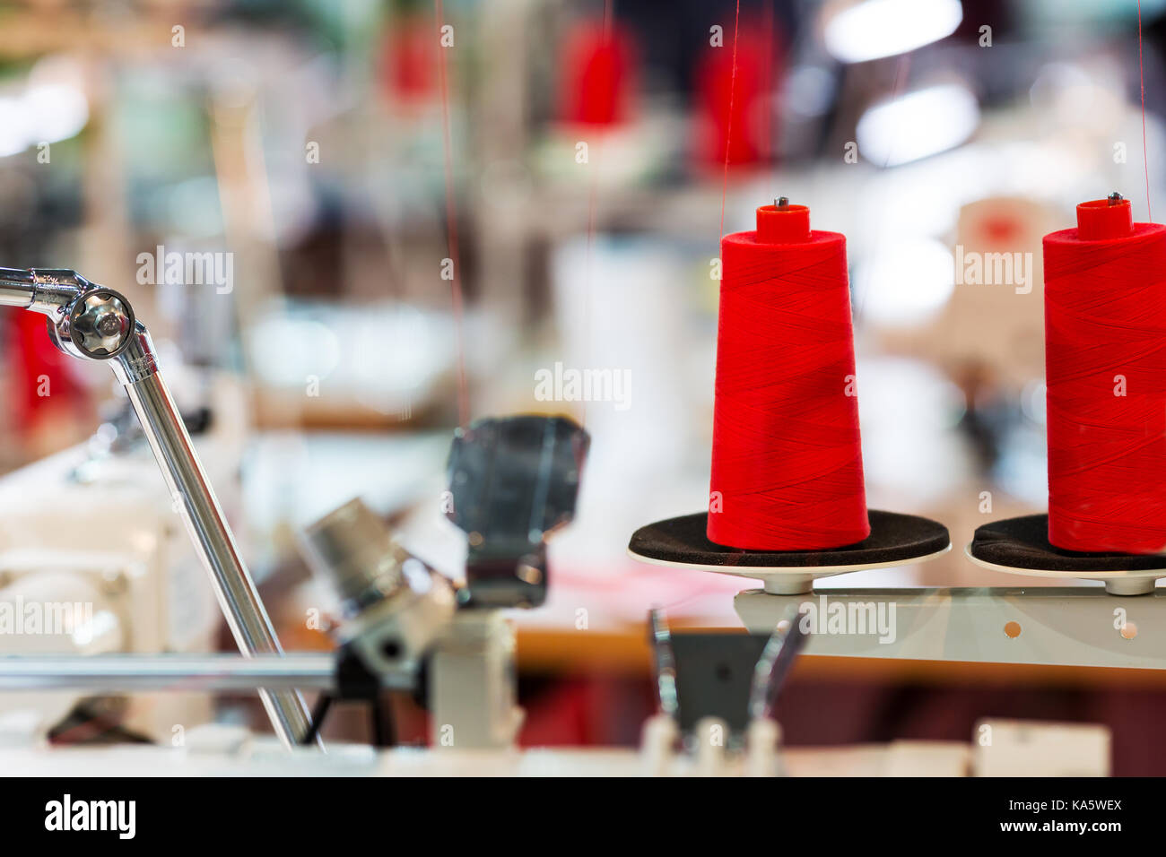 Spools of red threads on sewing machine. Cloth fabric, weaving, textile ...