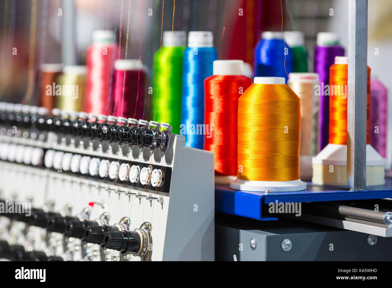 Spools of color threads closeup, spinning machine. Cloth factory ...