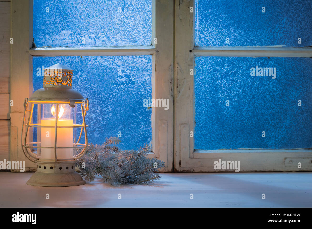 Blue window at night with burning candle for Christmas Stock Photo - Alamy