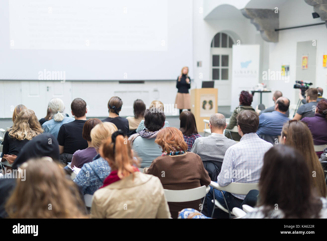 Woman giving presentation on business conference Stock Photo - Alamy