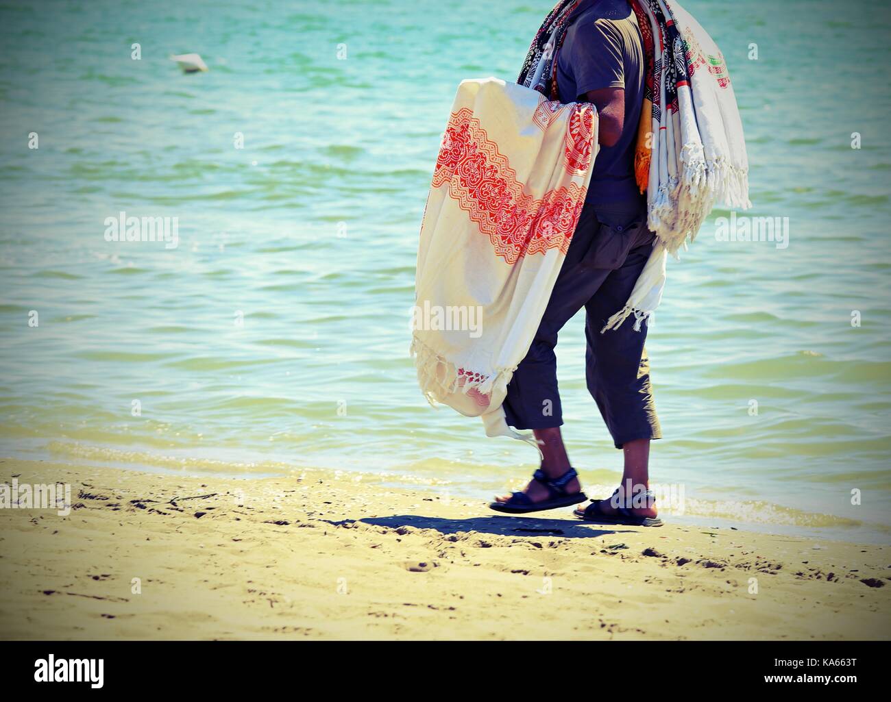 old peddler sale clothes on the beach in summer Stock Photo - Alamy