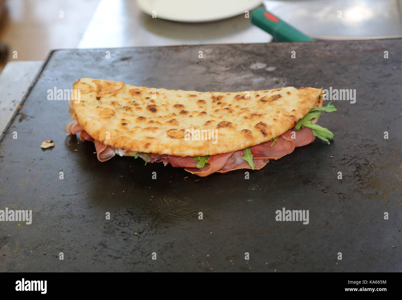 A tasty piadina that means flat bread in Italy stuffed with ham and ...