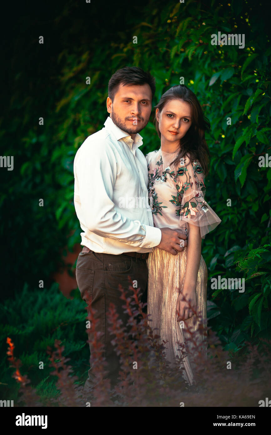 Beautiful young couple on a nature background Stock Photo - Alamy