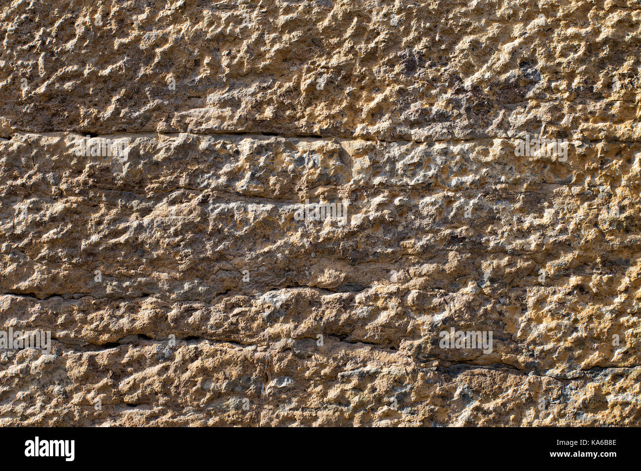 close up of a eroded texture of a beigh rough stone Stock Photo - Alamy