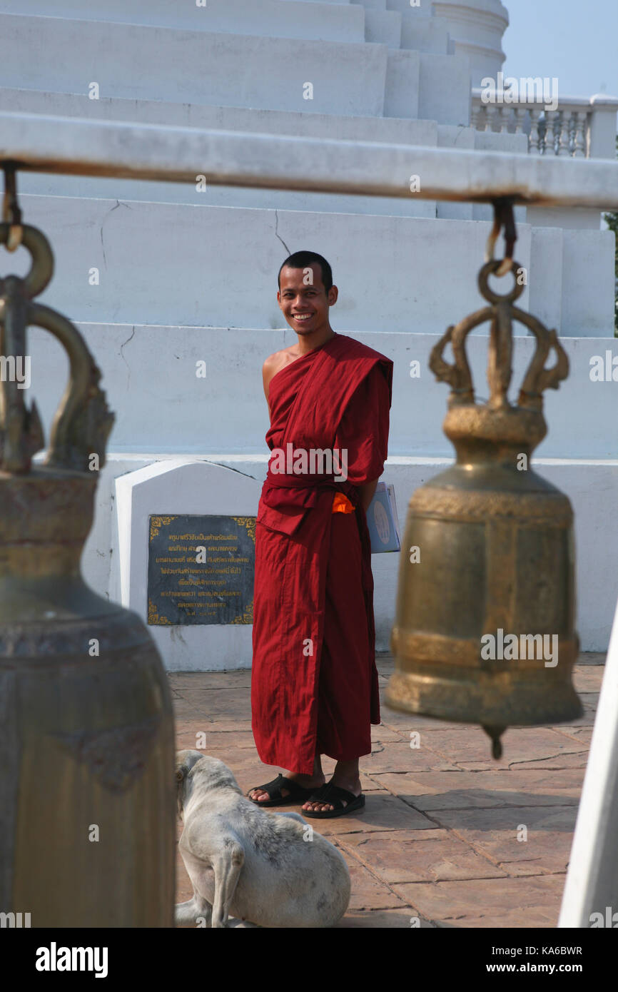 Daily life in a Buddhist monastery. Young cheerful smiling monk in a ...