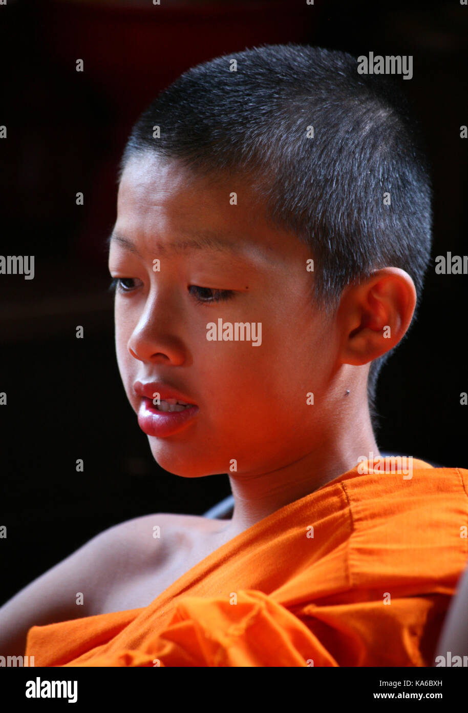 Daily life in a Buddhist monastery. Closeup portrait of young boy by ...