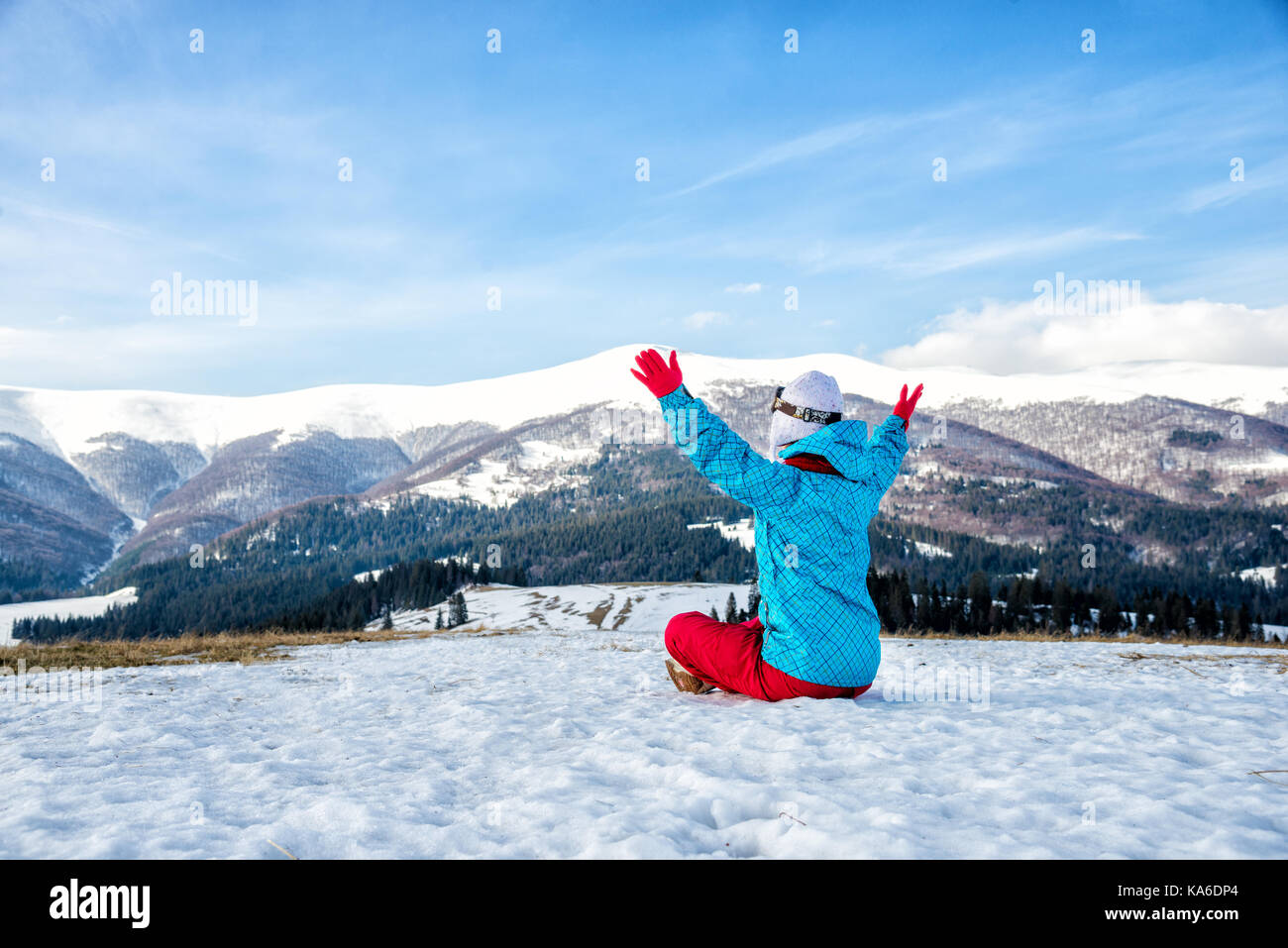 Young woman with snowboard sitting on the slope of hill Stock Photo - Alamy