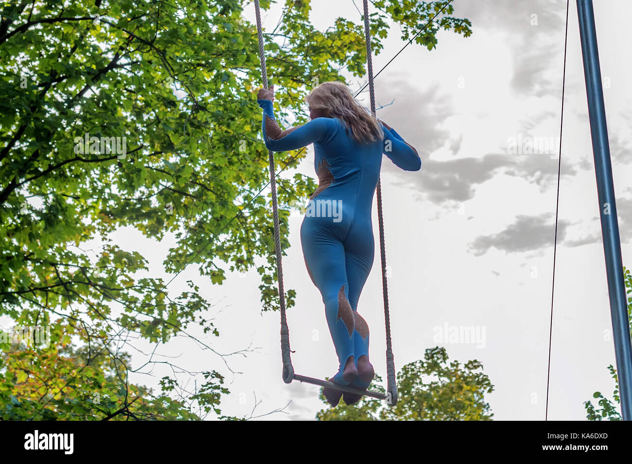 Back view young attractive female trapeze artist Stock Photo - Alamy