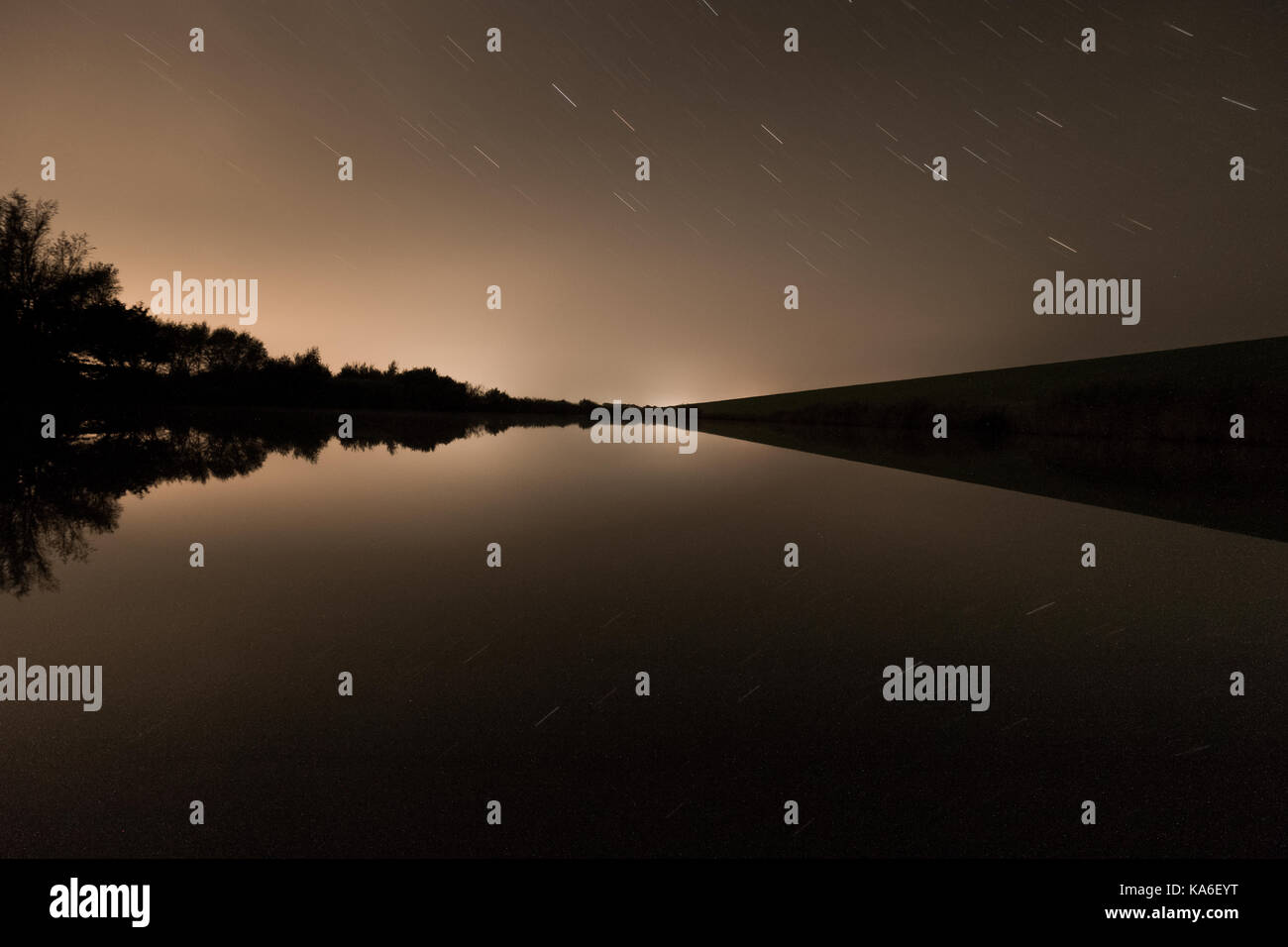Abstract view of a small lake with star trail reflection Stock Photo ...