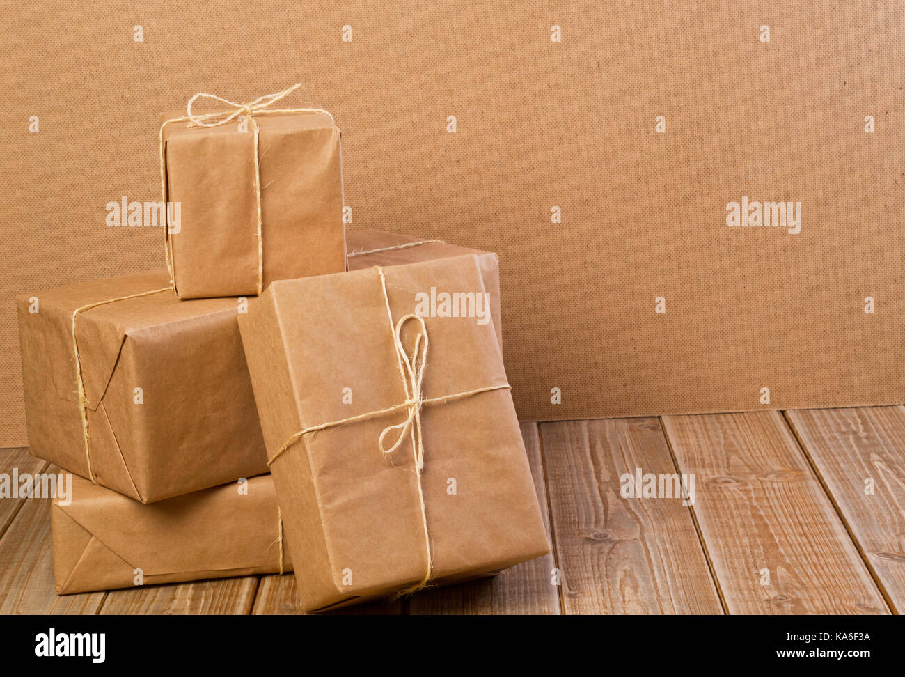 Parcel wrapped in brown paper and tied with rough twine Stock Photo - Alamy